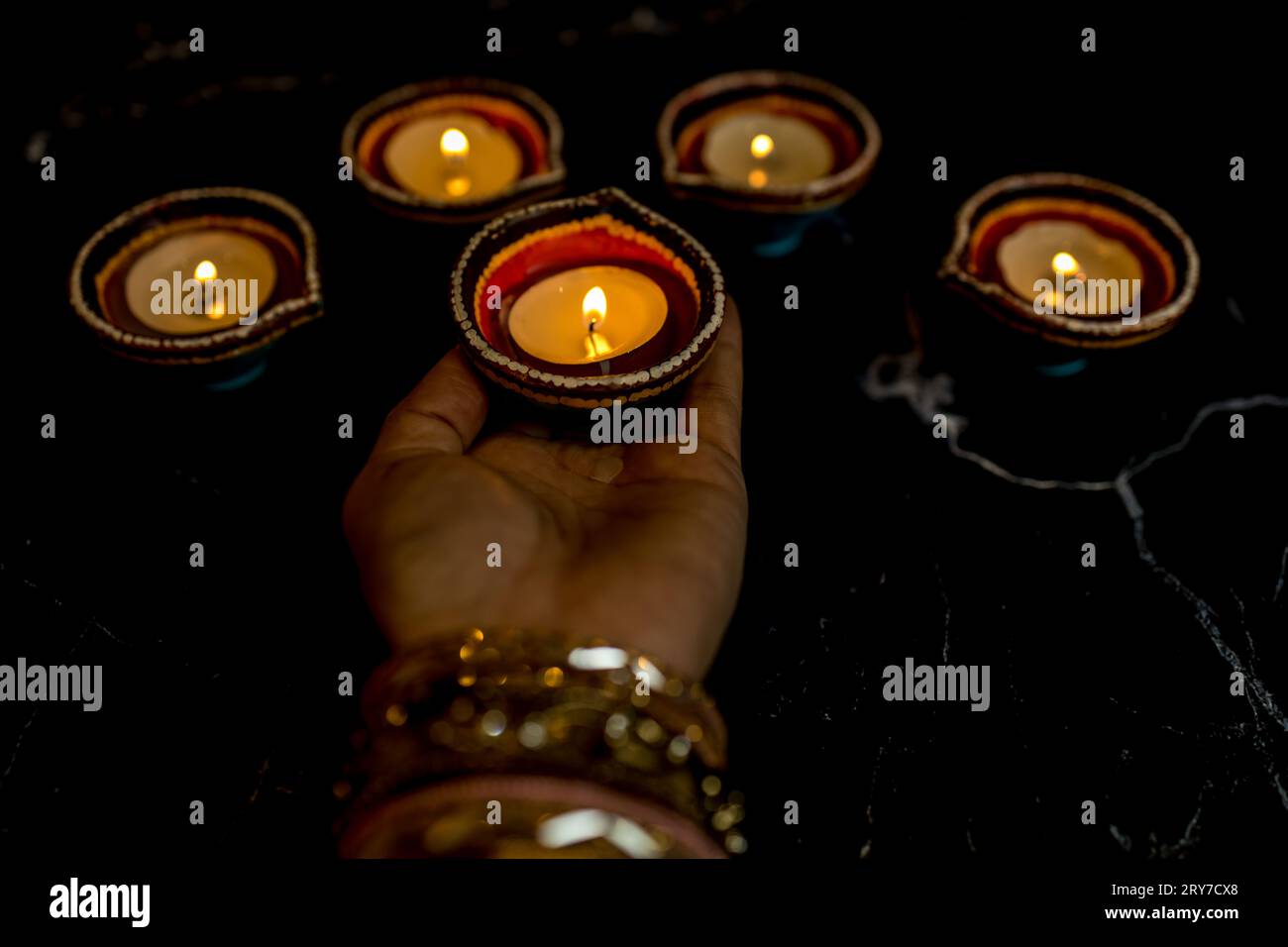 Happy Diwali - Woman hands with henna holding lit candle isolated on ...