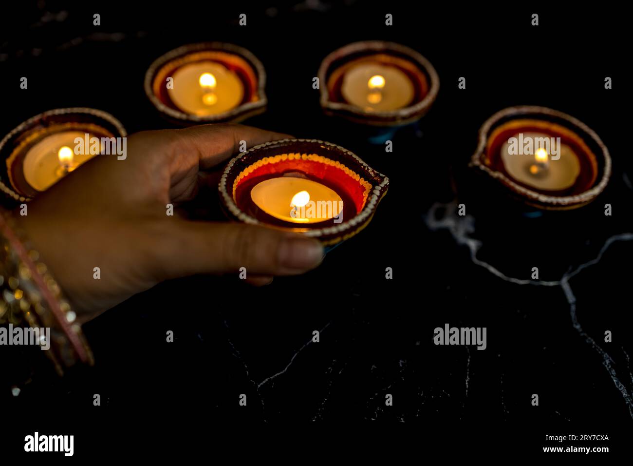 Happy Diwali - Woman hands with henna holding lit candle isolated on ...