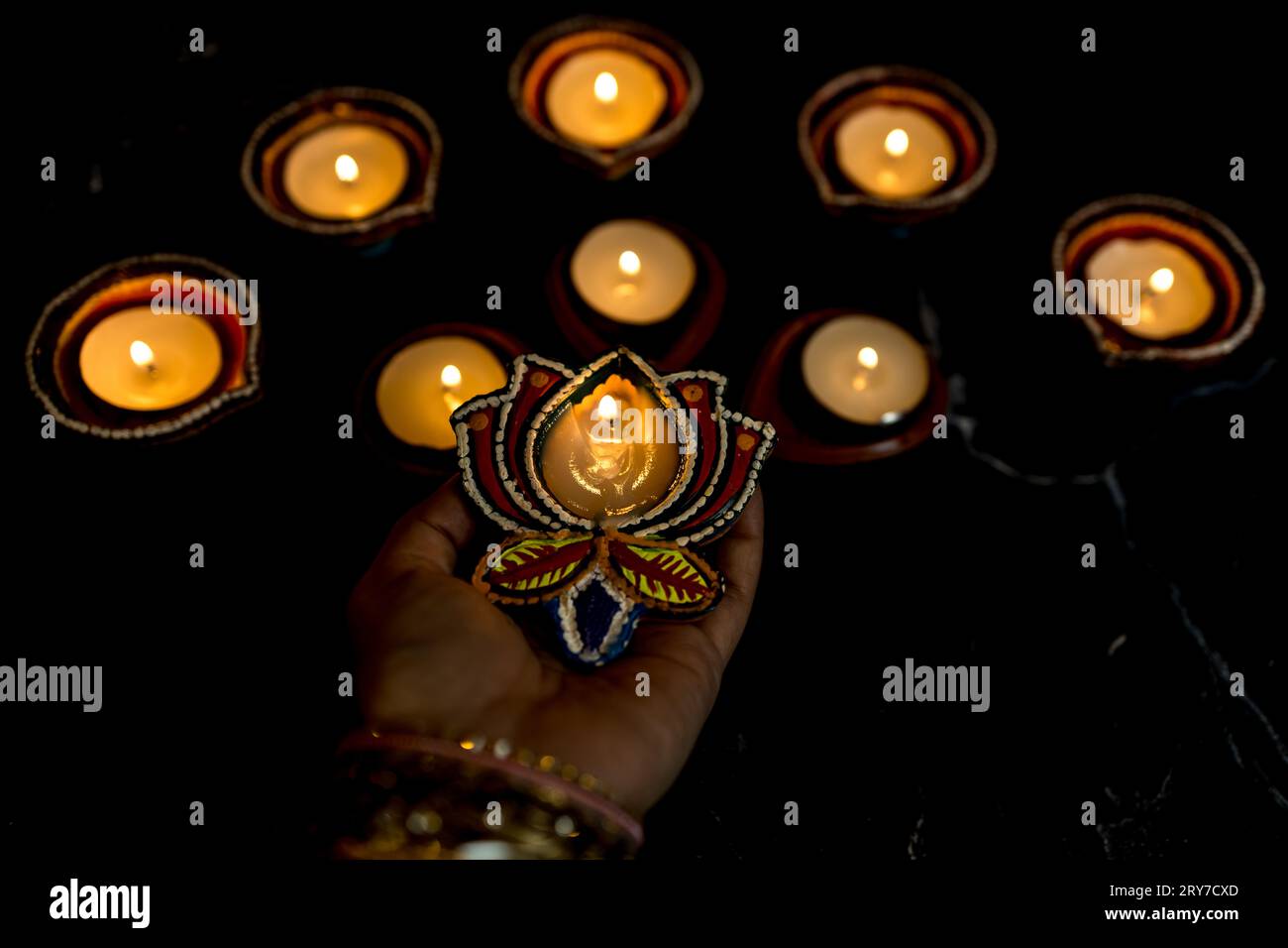 Happy Diwali - Woman hands with henna holding lit candle isolated on ...