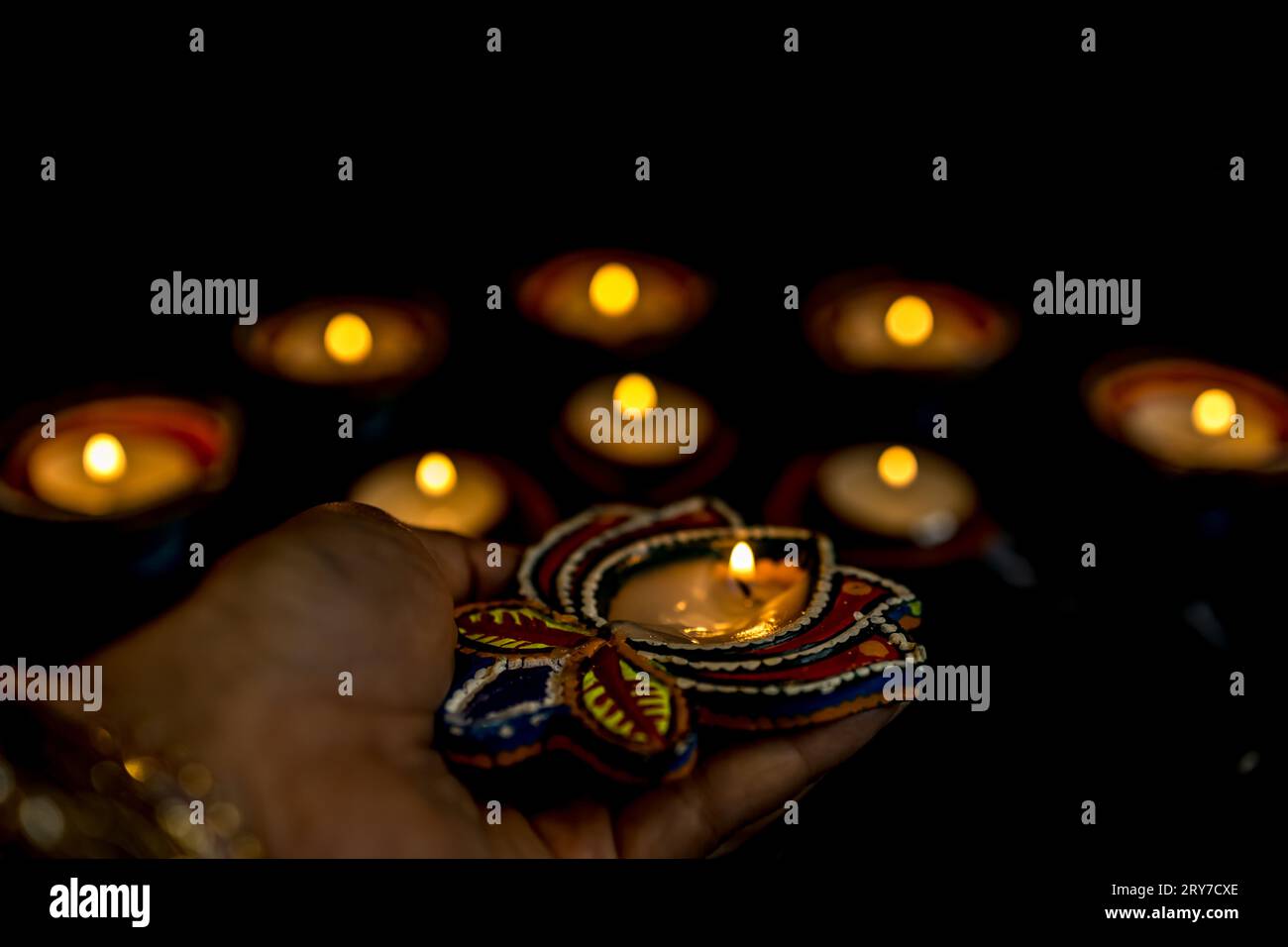 Happy Diwali - Woman hands with henna holding lit candle isolated on ...