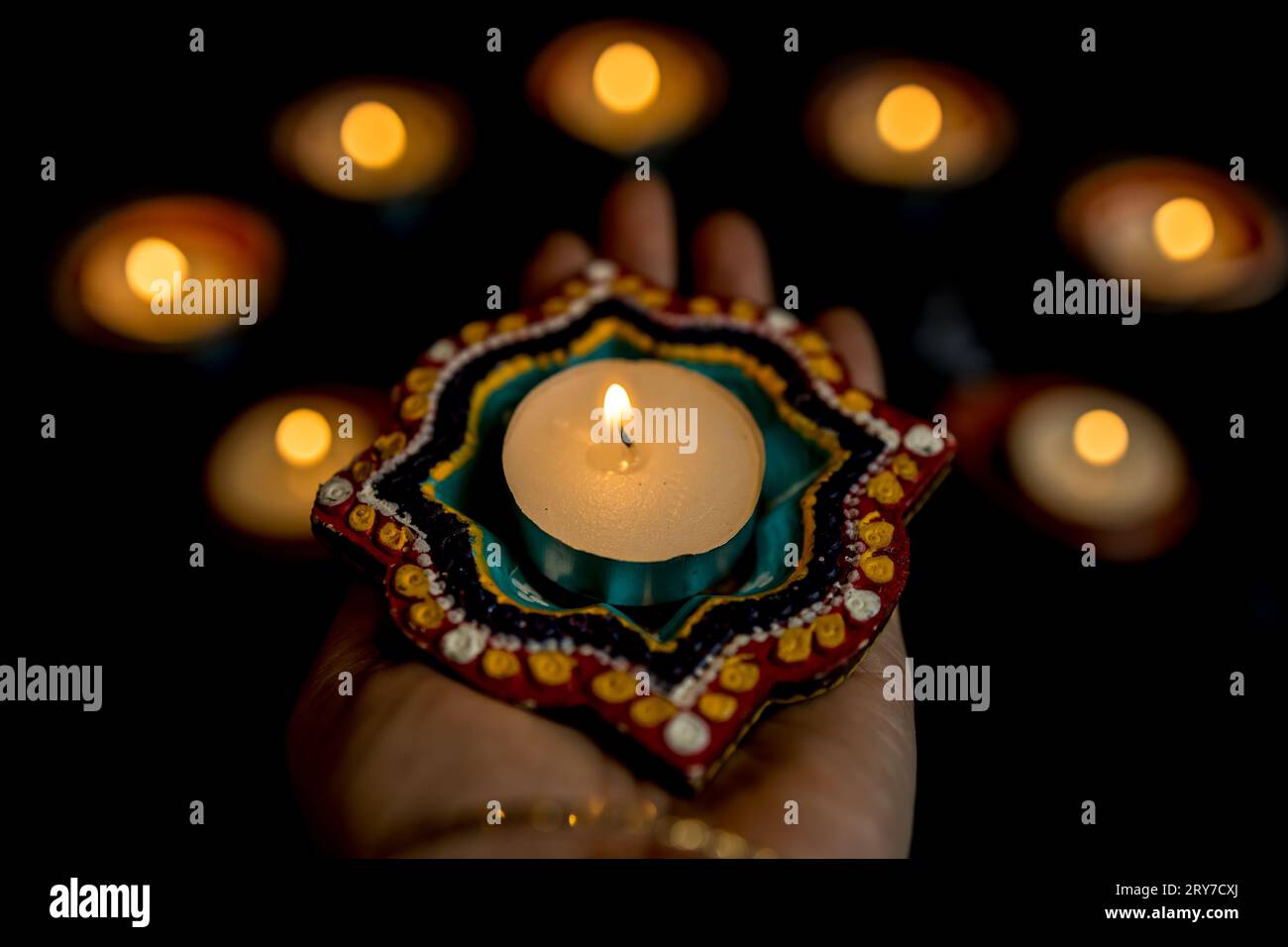 Happy Diwali - Woman hands with henna holding lit candle isolated on ...