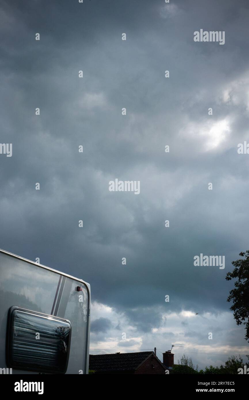 caravan and house under stormy heavy rain laden sky ellingham norfolk ...