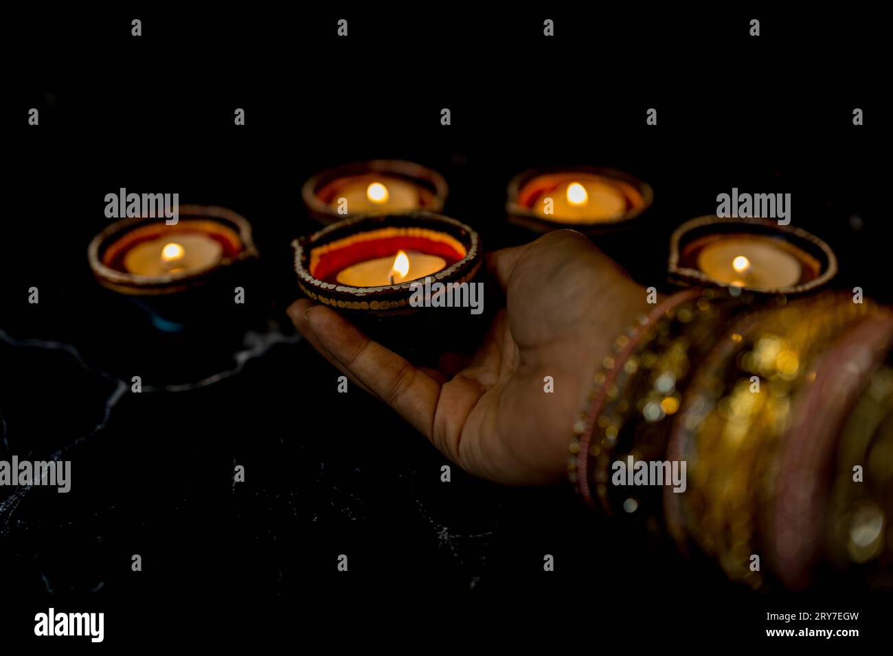 Happy Diwali - Woman hands with henna holding lit candle isolated on ...
