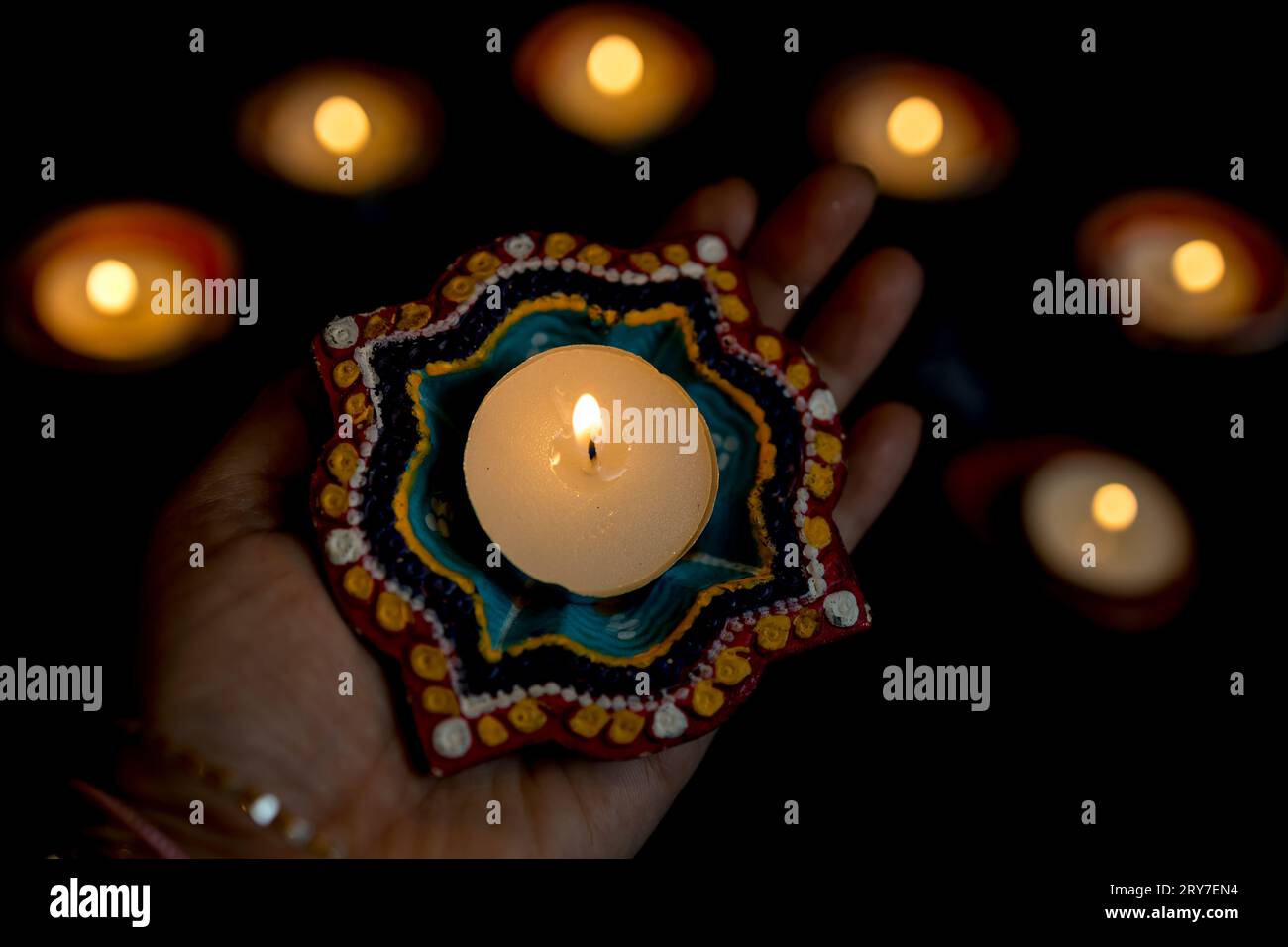 Happy Diwali - Woman hands with henna holding lit candle isolated on ...