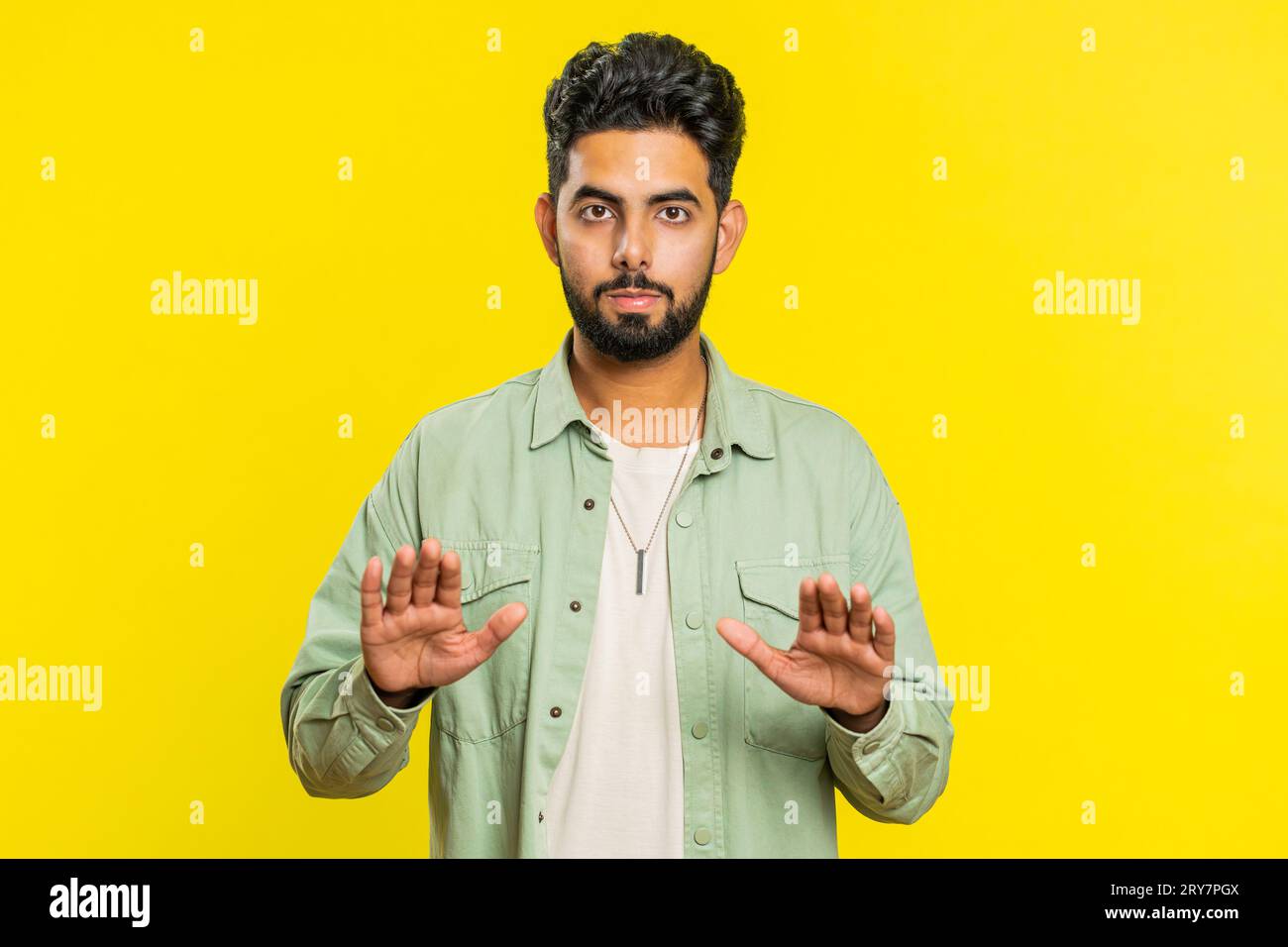 Hey you, be careful. Strict Indian man warning with admonishing hands ...