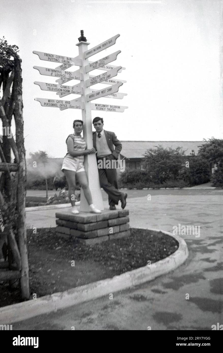 1960s, historical, a young man and woman standing for a photo by a ...