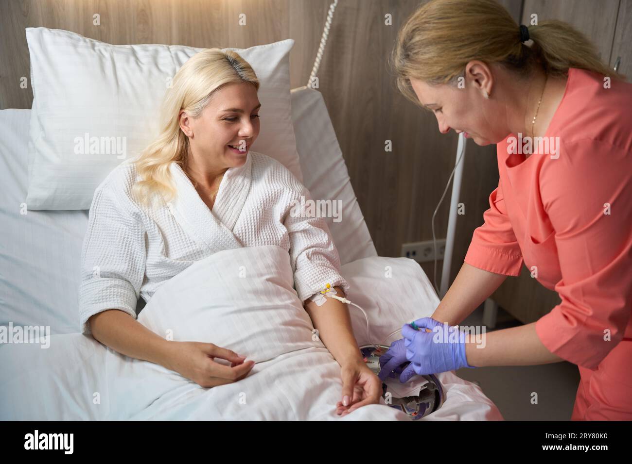 Nurse puts drip on patient hi-res stock photography and images - Alamy