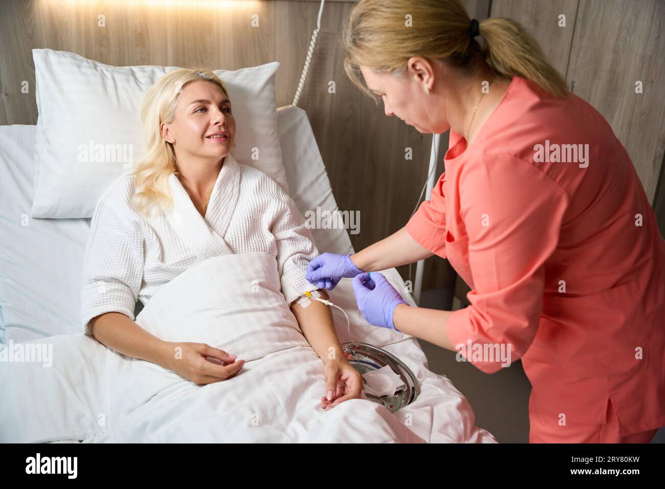 Nurse puts drip on patient hi-res stock photography and images - Alamy