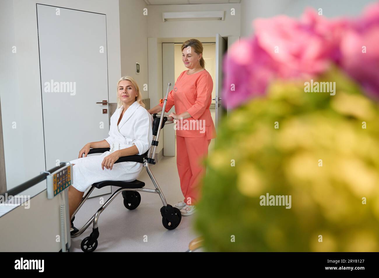 Paramedic brought a lady to a hospital room in wheelchair Stock Photo ...