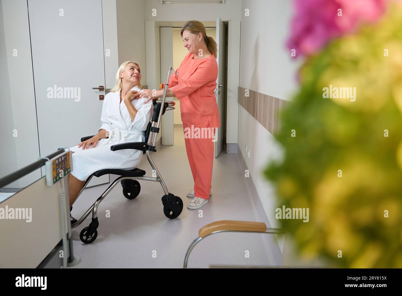 Kind paramedic brought a lady to hospital room in wheelchair Stock ...