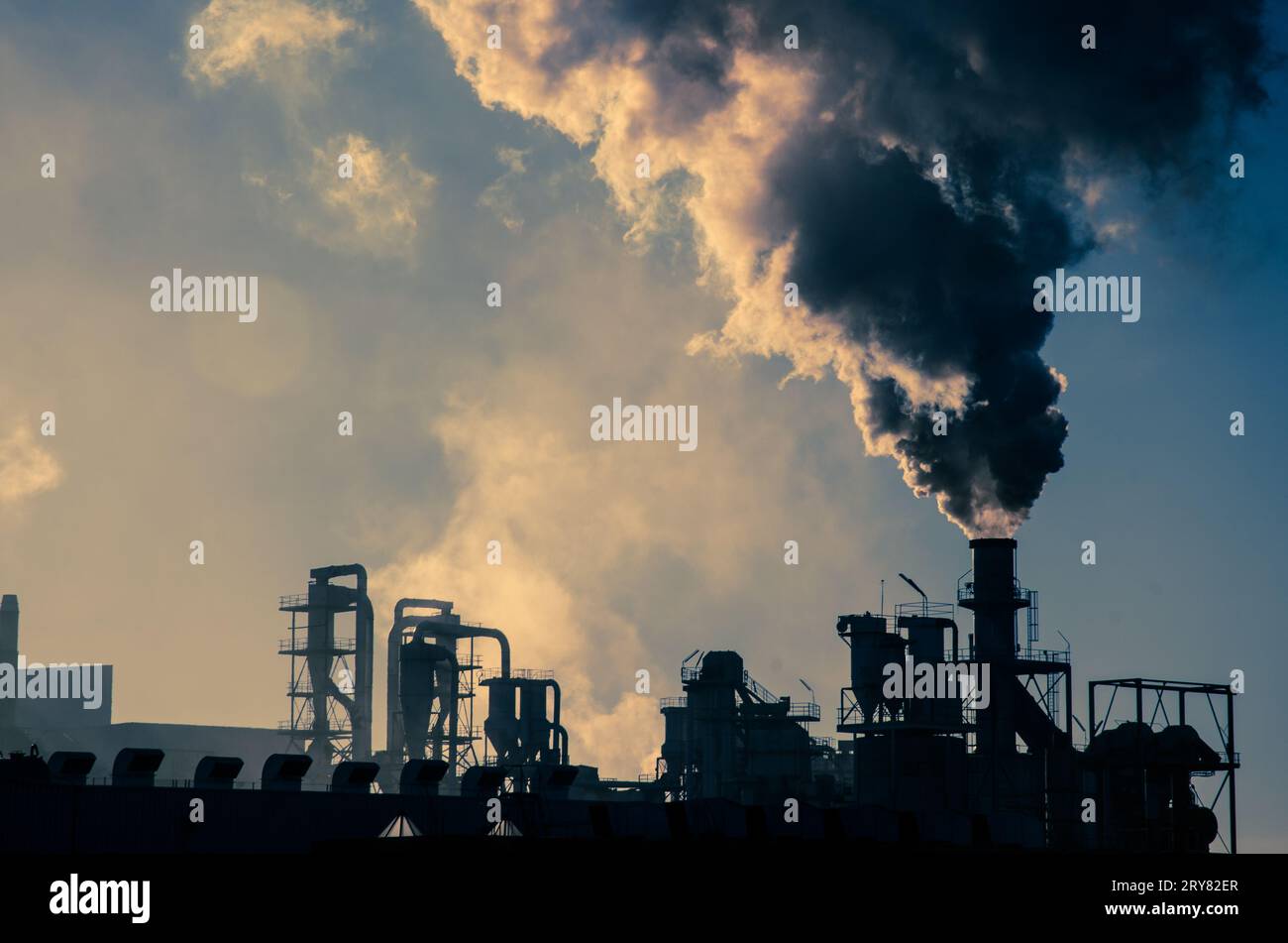 Smoking chimney at sunset Stock Photo - Alamy