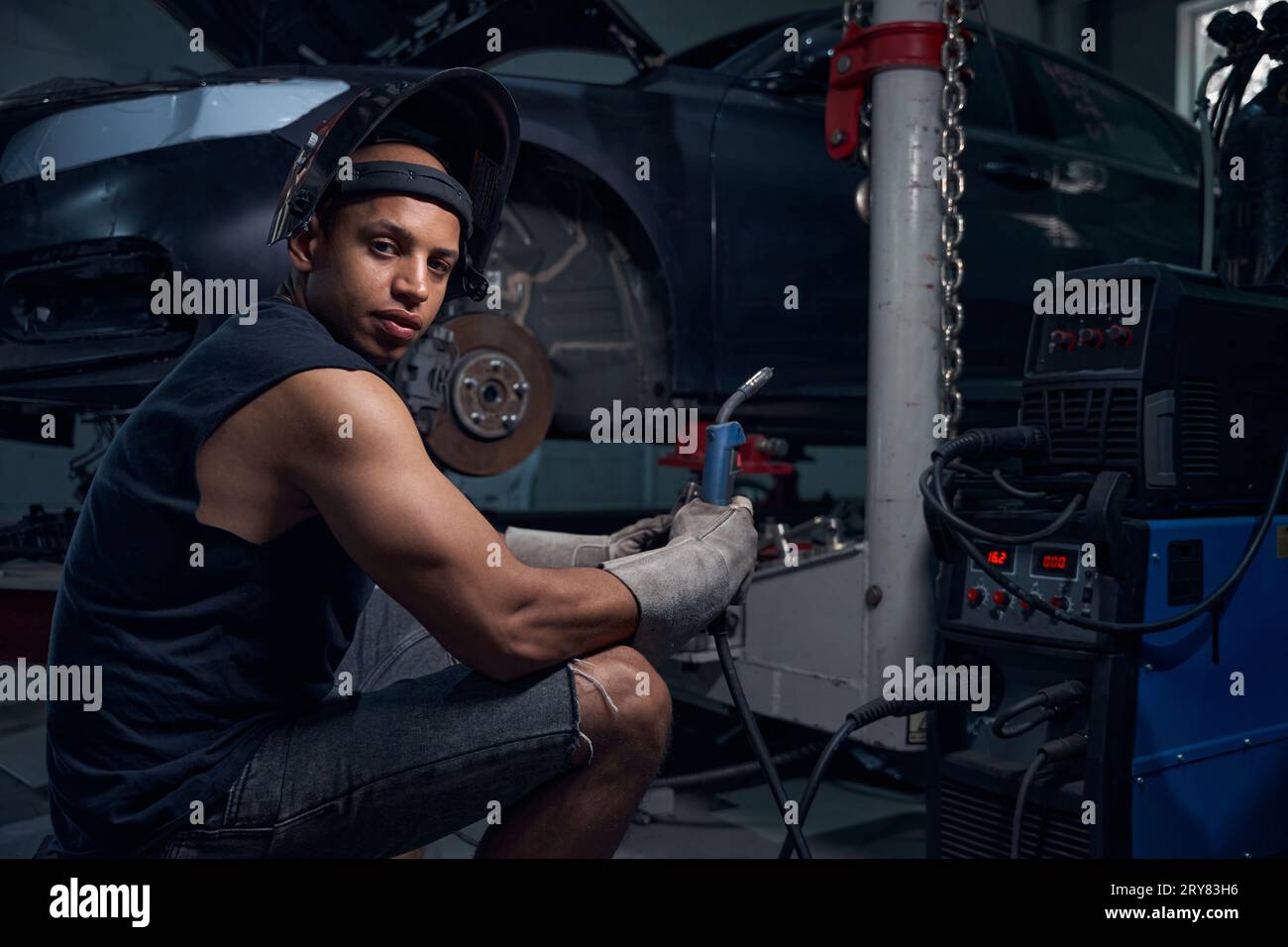 Male worker adjusting metal machine hi-res stock photography and images ...