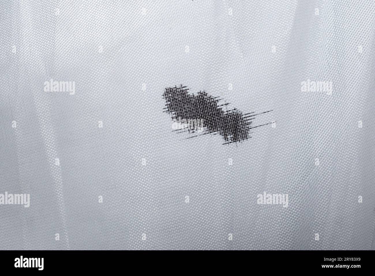 Black ink stain on white sinthetic fiber fabric Stock Photo - Alamy