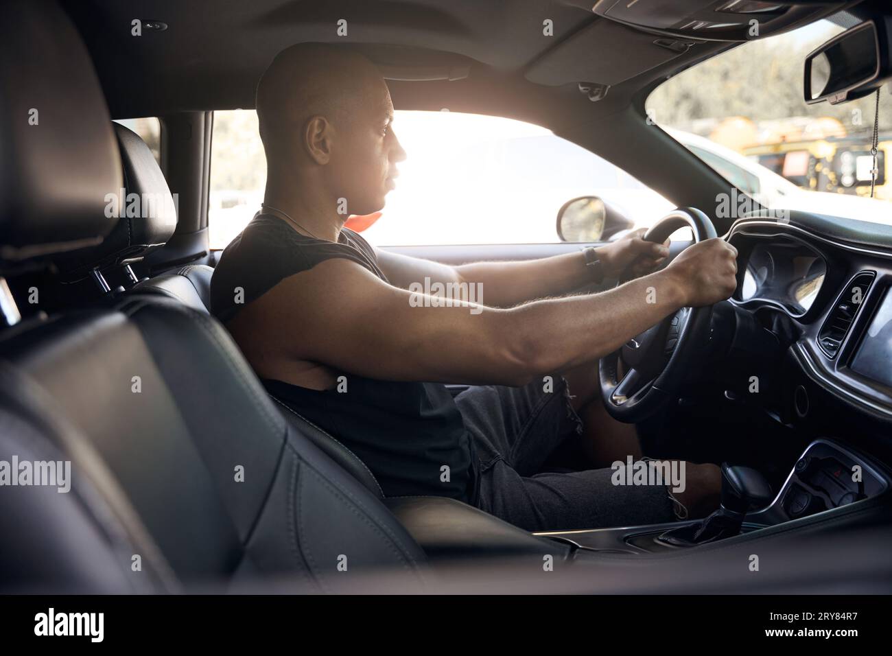 Self-confident man test-driving new car in salon Stock Photo - Alamy