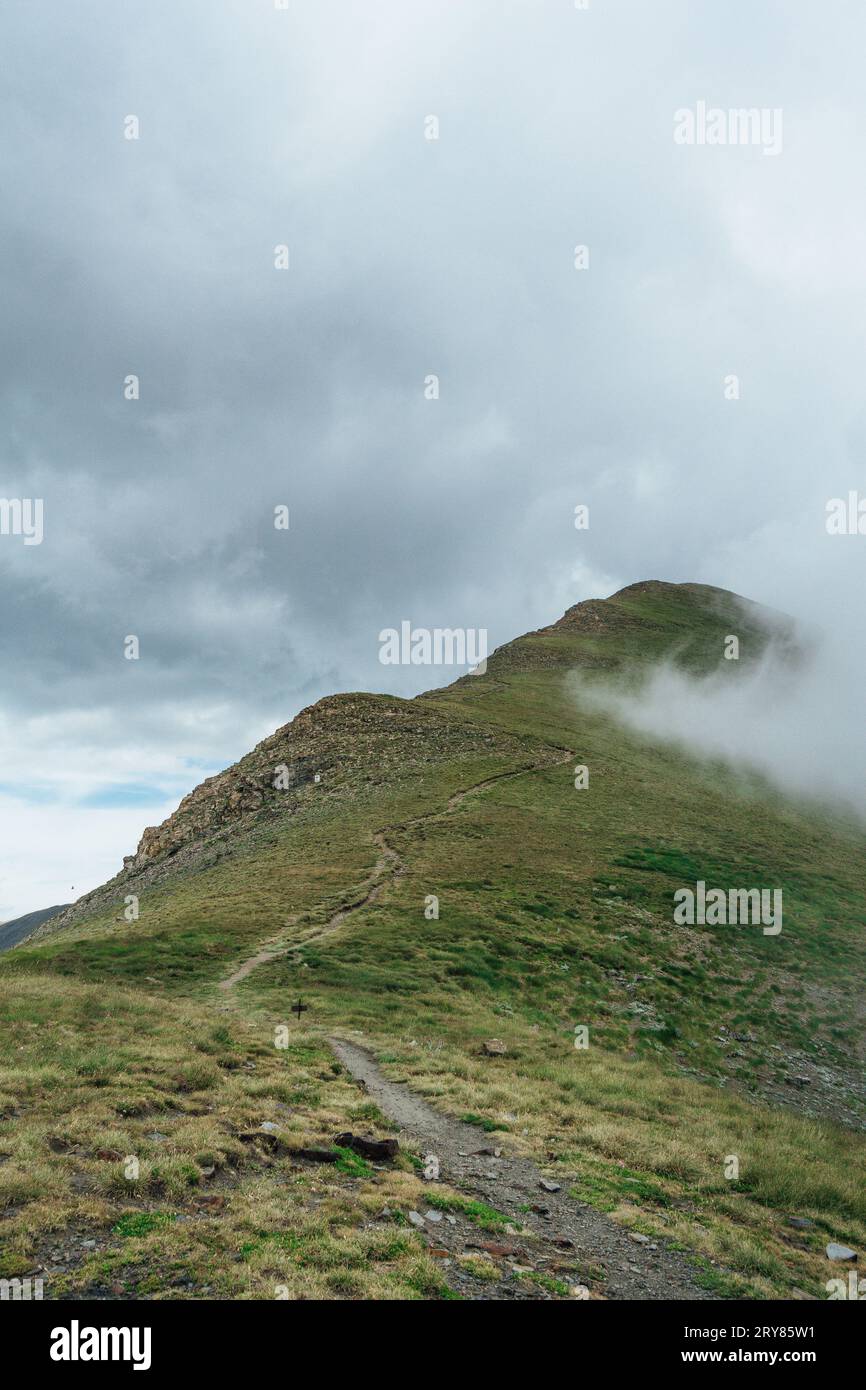 Guiding path on a cloudy mountain in Spanish Pyrenees Stock Photo - Alamy