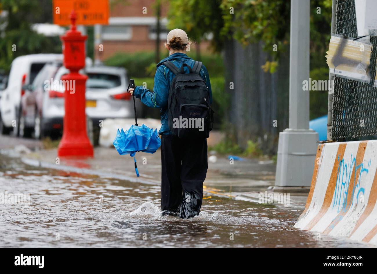 New York, United States. 29th Sep, 2023. A pedestrian walks through a ...