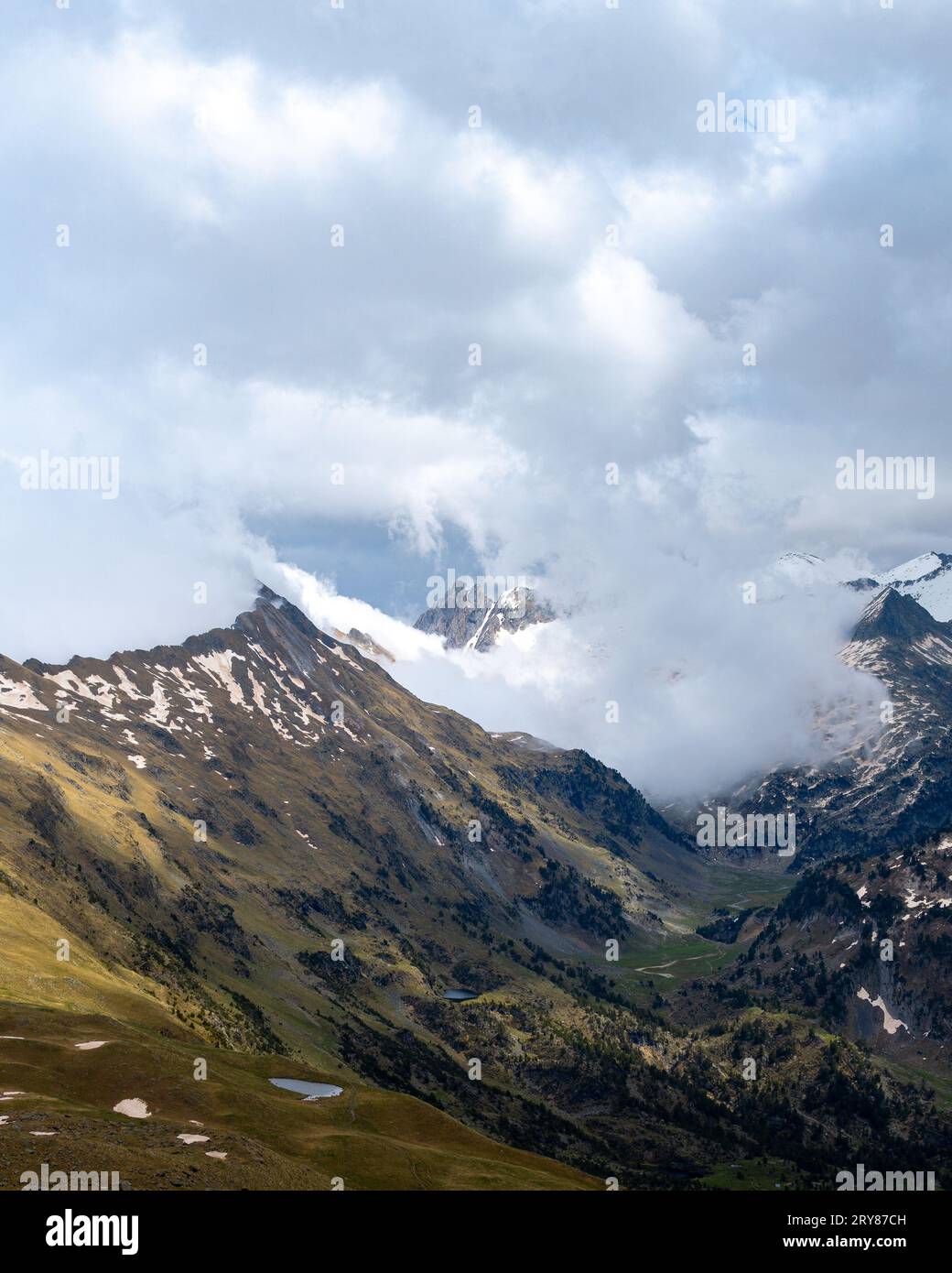 View over snowy peak through cloud in the Spanish Pyrenees Stock Photo ...