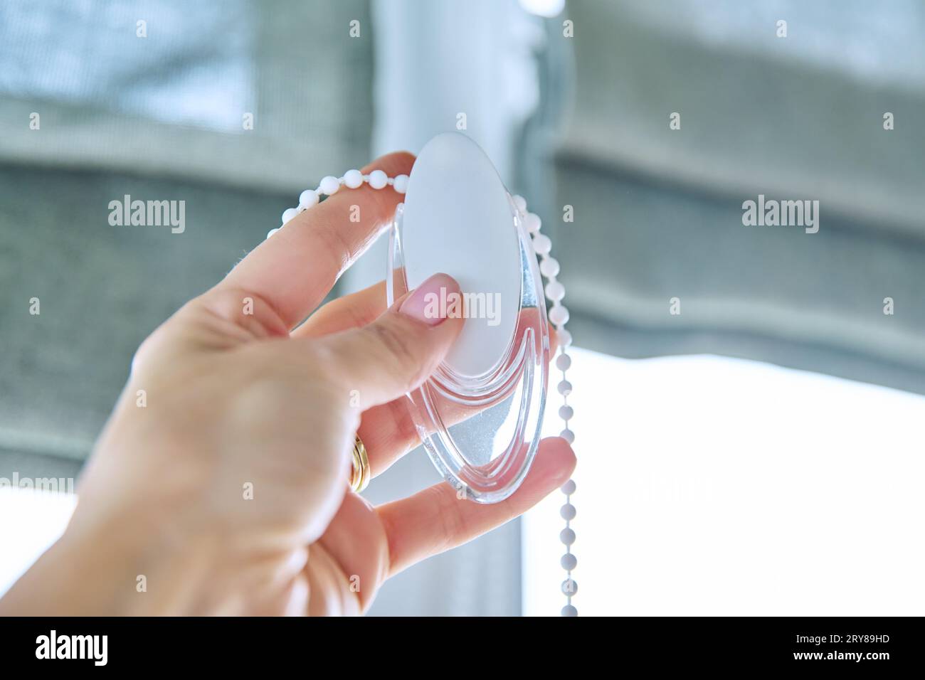 Close-up of chain with weight for opening and closing roman blinds ...
