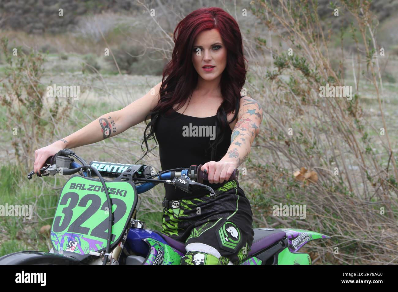 Photo of beautiful biker girl in biking outfit with bikes Stock Photo ...