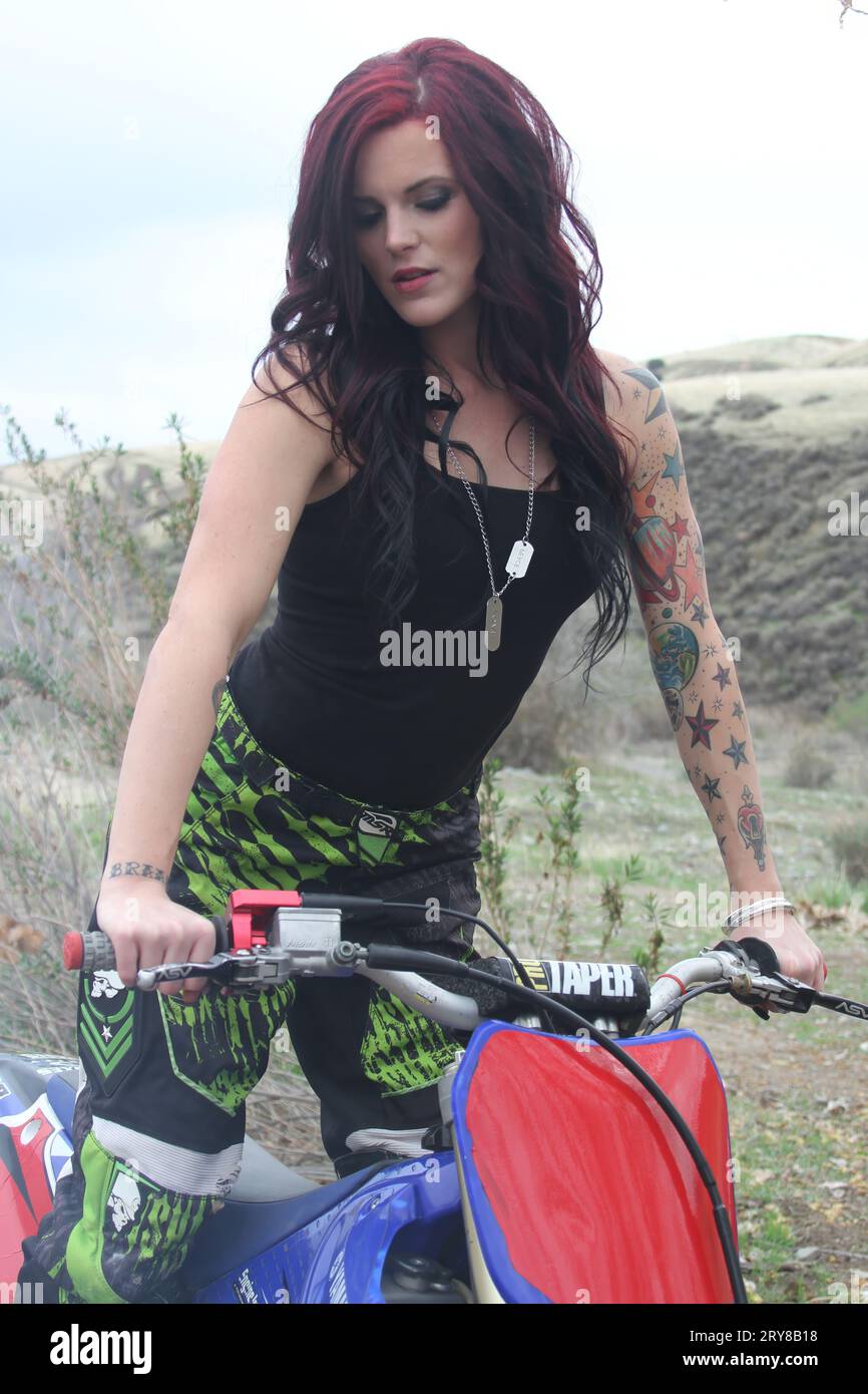 Photo of beautiful biker girl in biking outfit with bikes Stock Photo ...