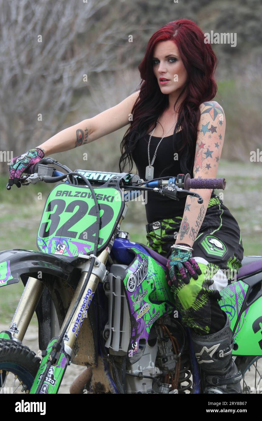Photo of beautiful biker girl in biking outfit with bikes Stock Photo ...
