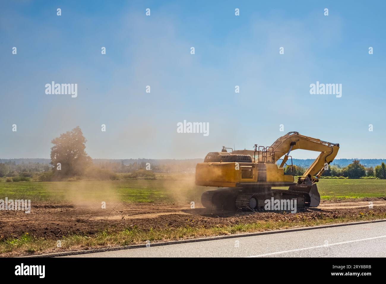 Industrial heavy duty excavator loading soil material from highway ...