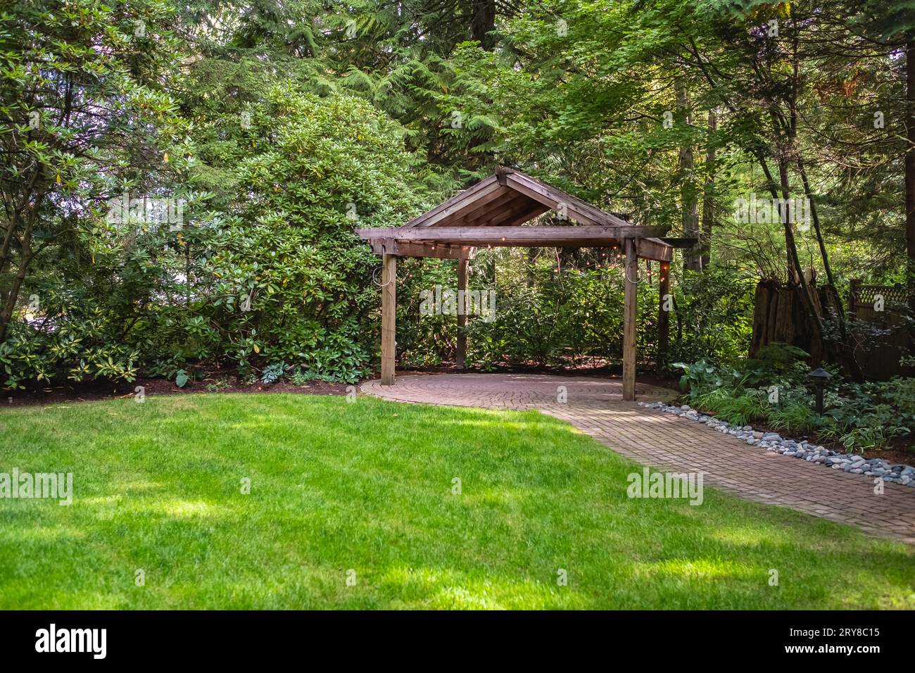 Pavilion, pergola in the garden surrounded by greenery and a lawn ...
