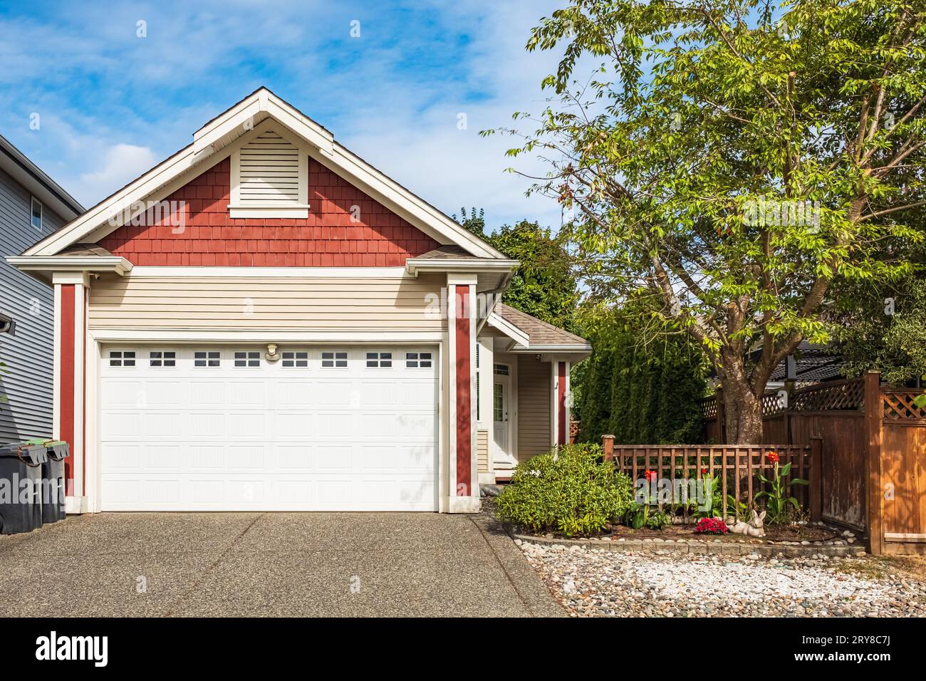 Garage with short driveway in a sunny summer day. Garage door in ...