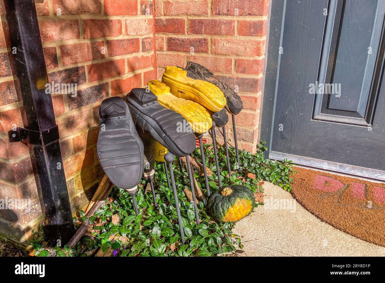 Wellington, rubber boots rack / holder in front of a front door of a ...