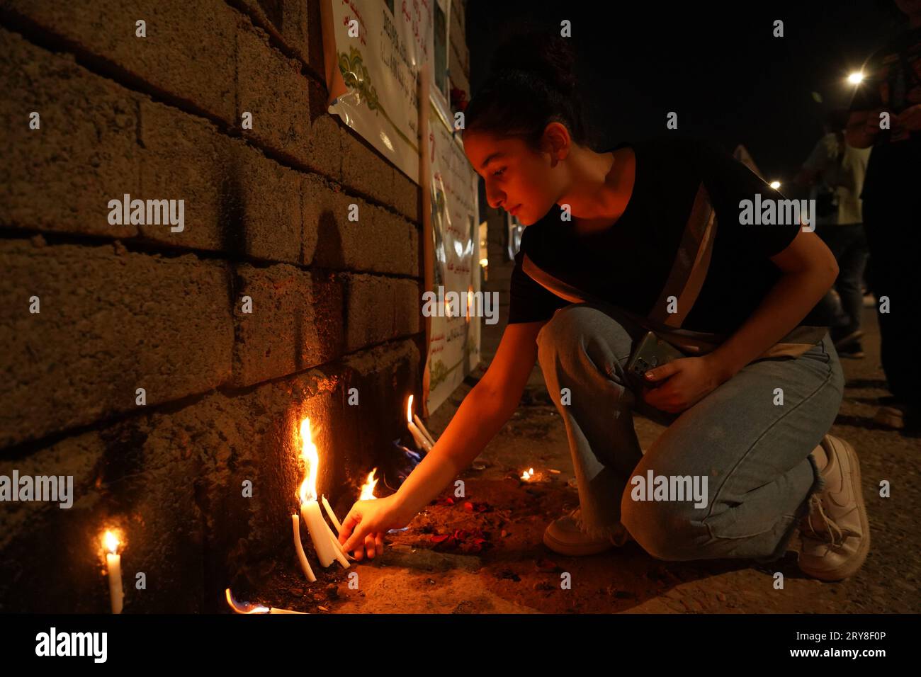 Hamdaniya, Iraq. 29th Sep, 2023. A girl lights candles outside St Mary ...
