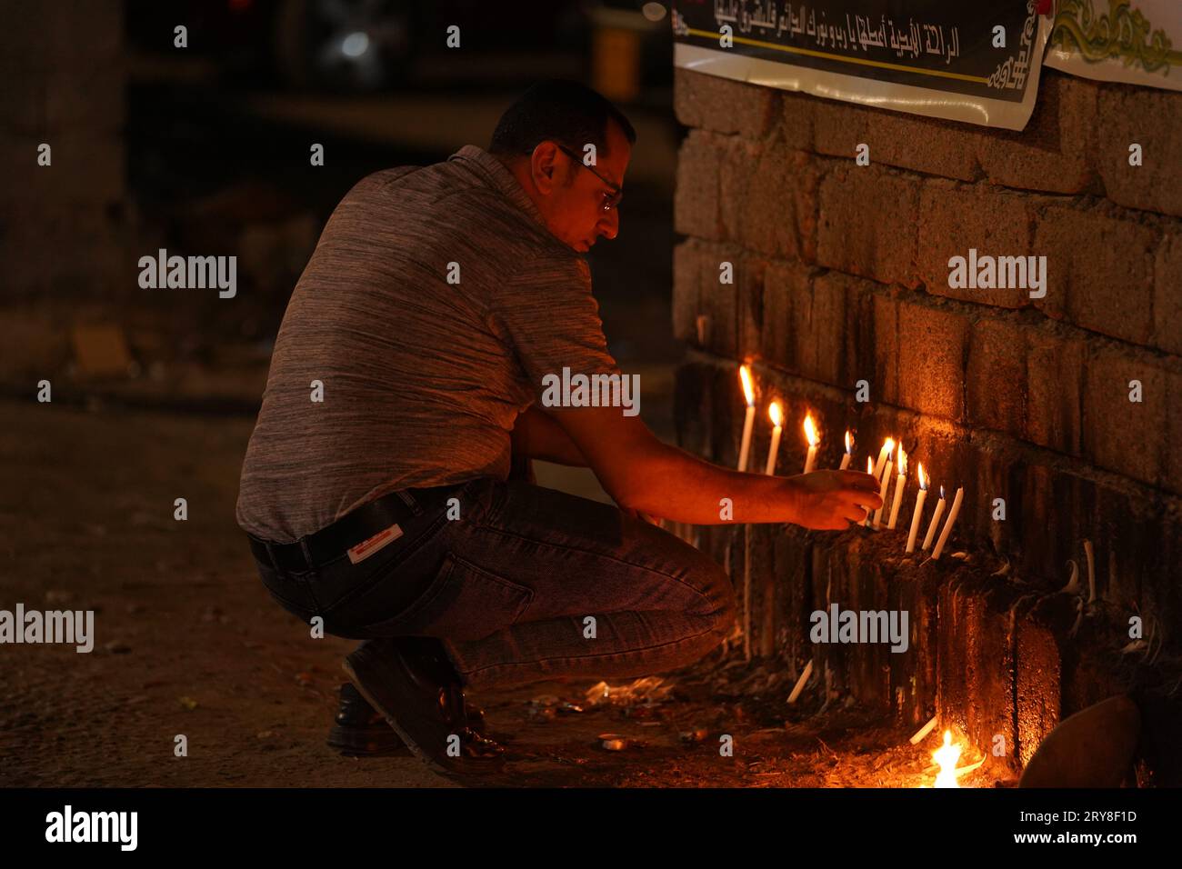 Hamdaniya, Iraq. 29th Sep, 2023. A man lights candles outside St Mary ...