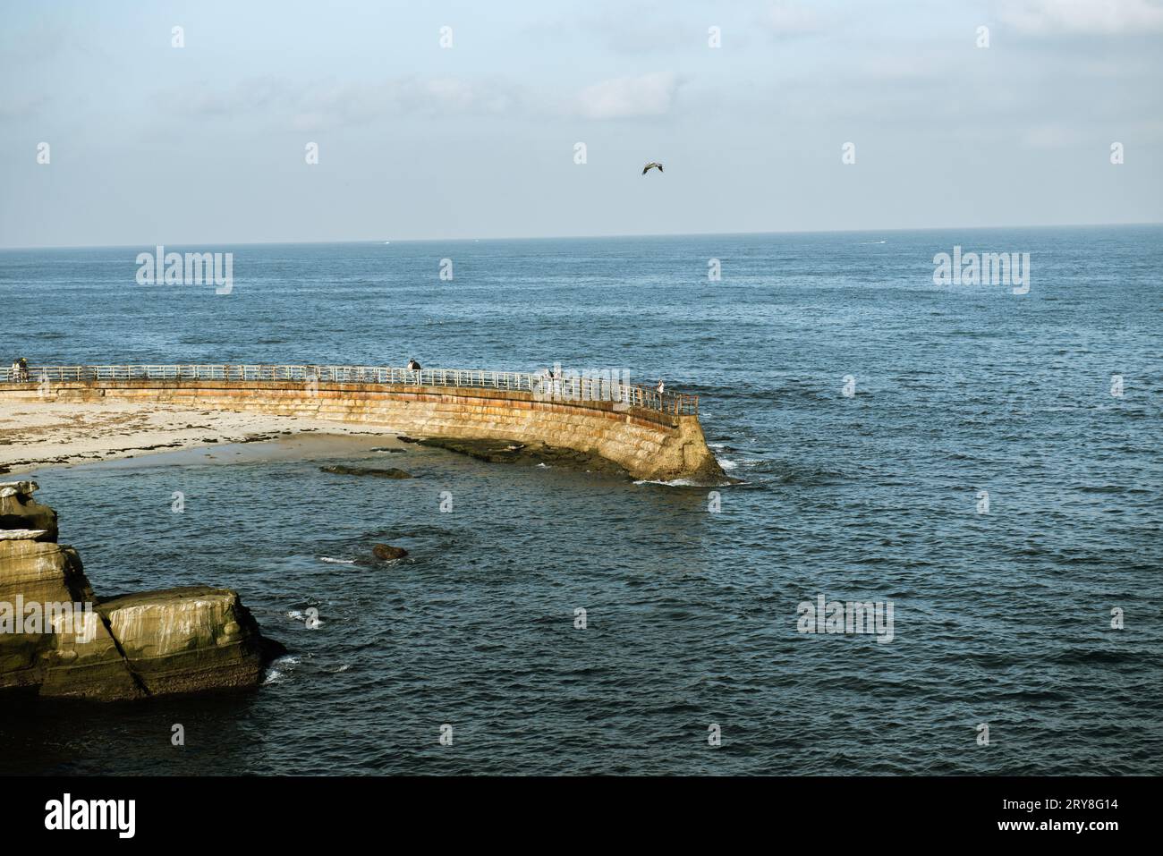 curved ocean pier with waves Stock Photo - Alamy