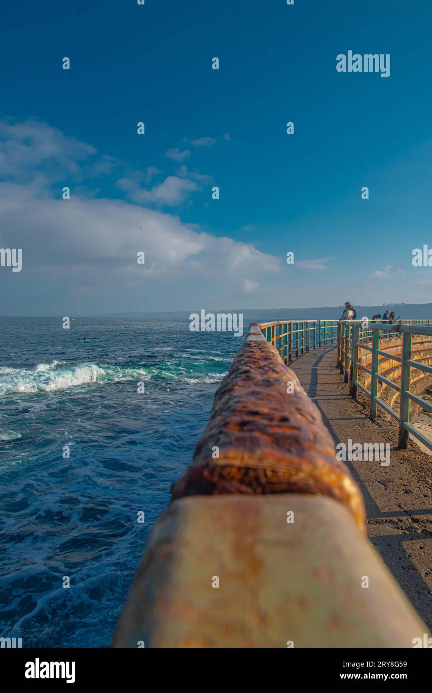 curved ocean pier with waves Stock Photo - Alamy