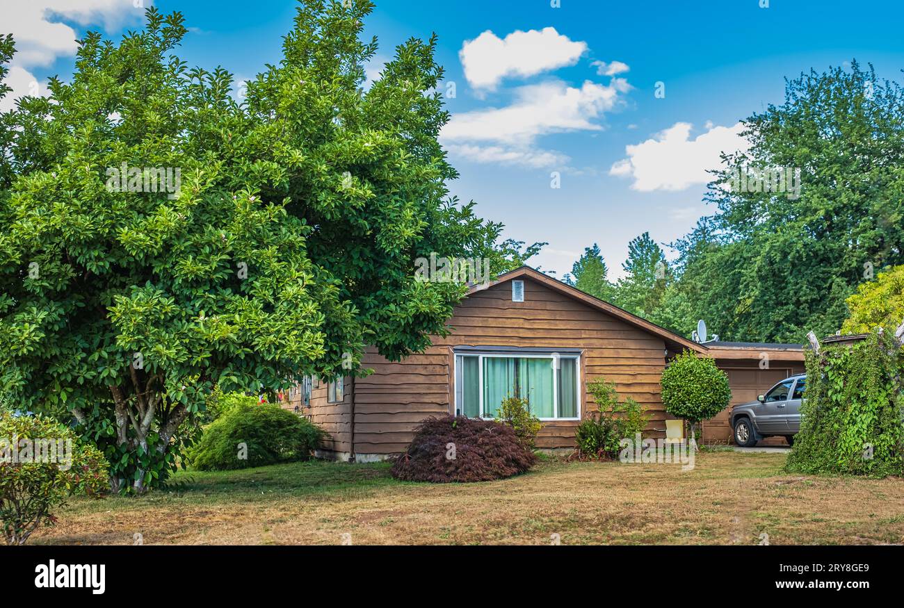 Typical wooden country house with lawn. Small wooden house in rural ...