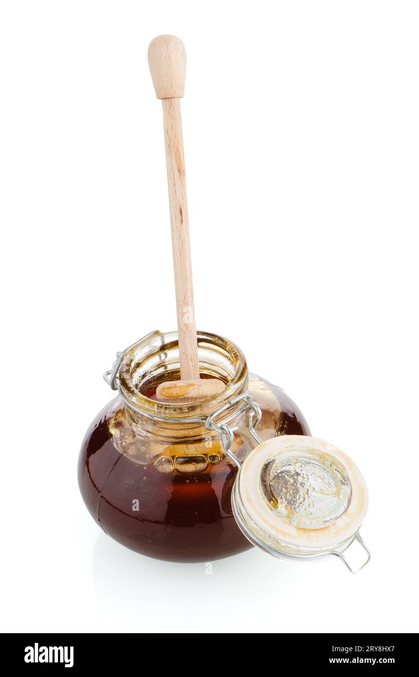 Jar of honey with wooden drizzler Stock Photo - Alamy