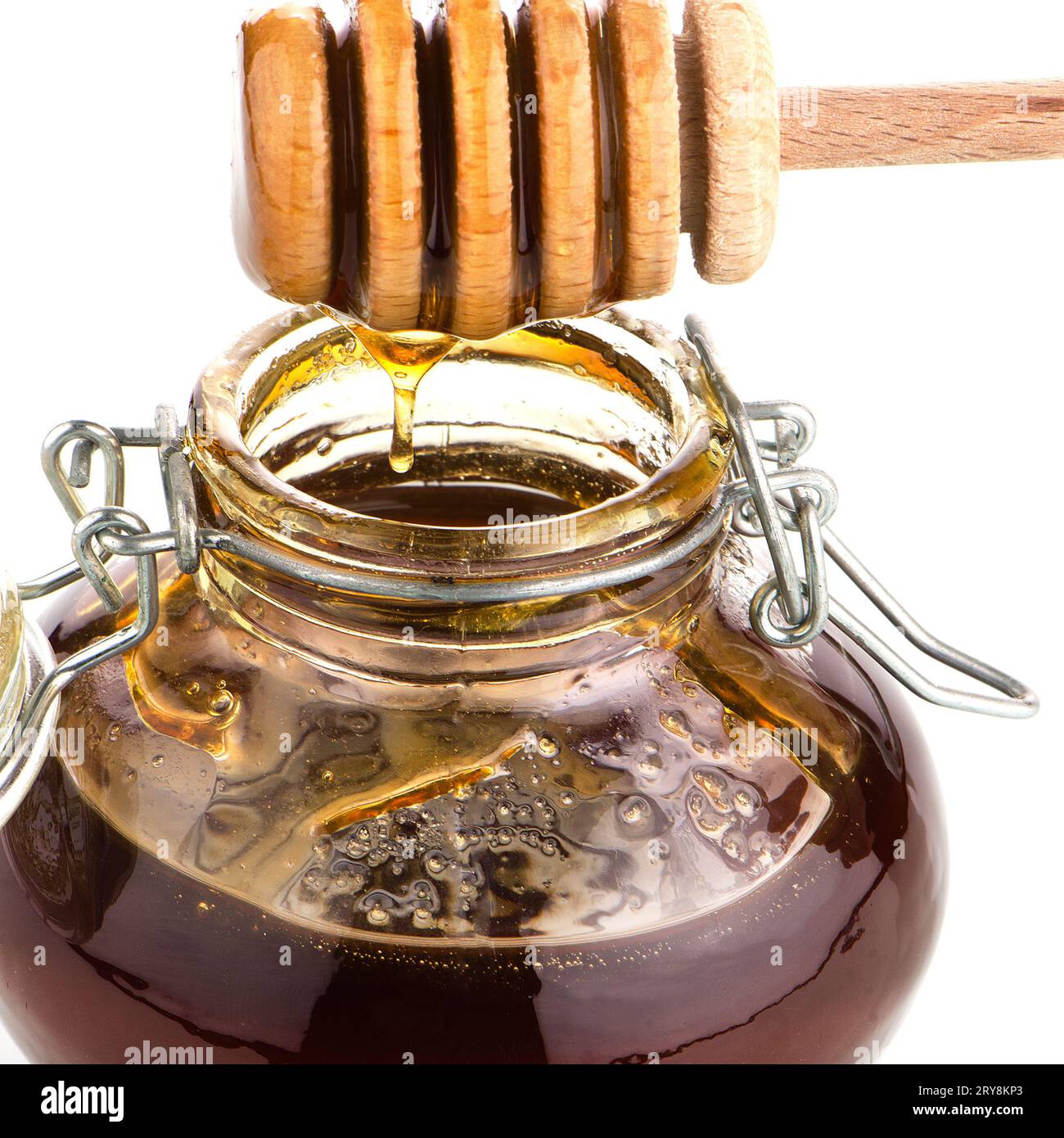 Jar of honey with wooden drizzler Stock Photo - Alamy