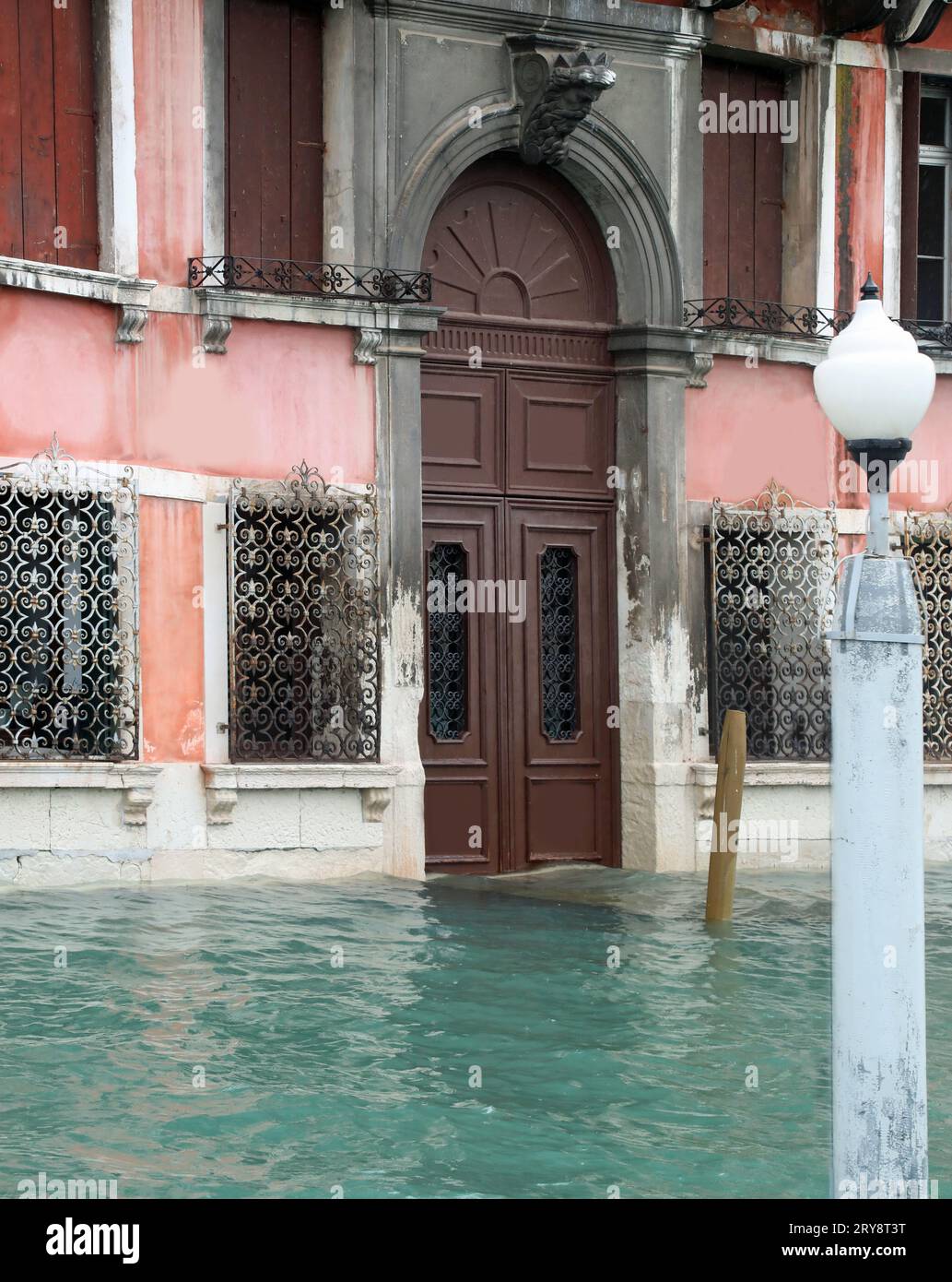 door of a Venetian house submerged by water during high tide in winter ...