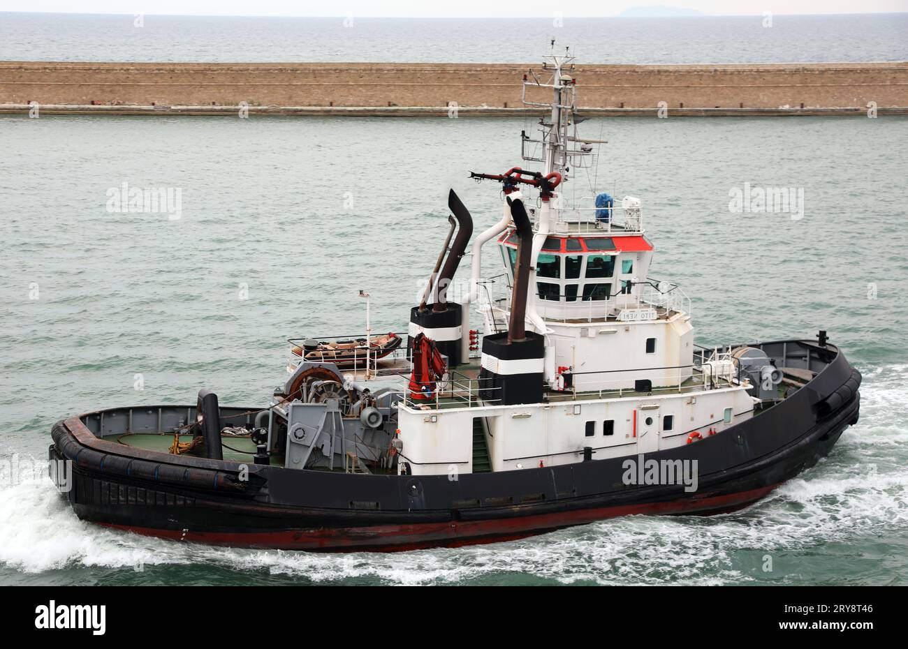 powerful tugboat with reinforced edges To tow large cruise ships inside the Port Stock Photo - Alamy