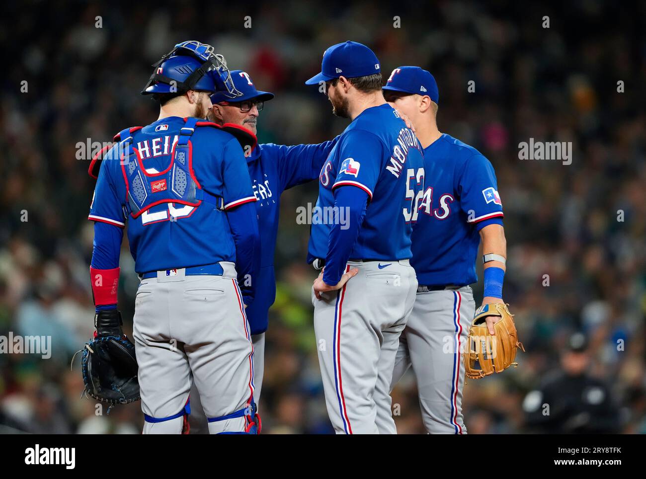 Texas Rangers manager Bruce Bochy, second from left, talks with ...