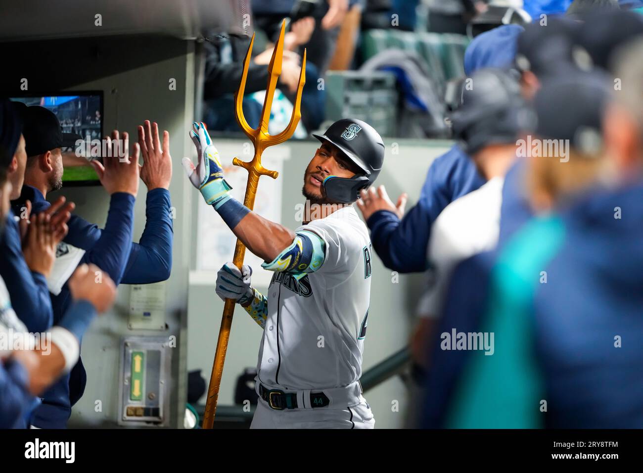 Seattle Mariners' Julio Rodríguez holds a trident in the dugout after ...