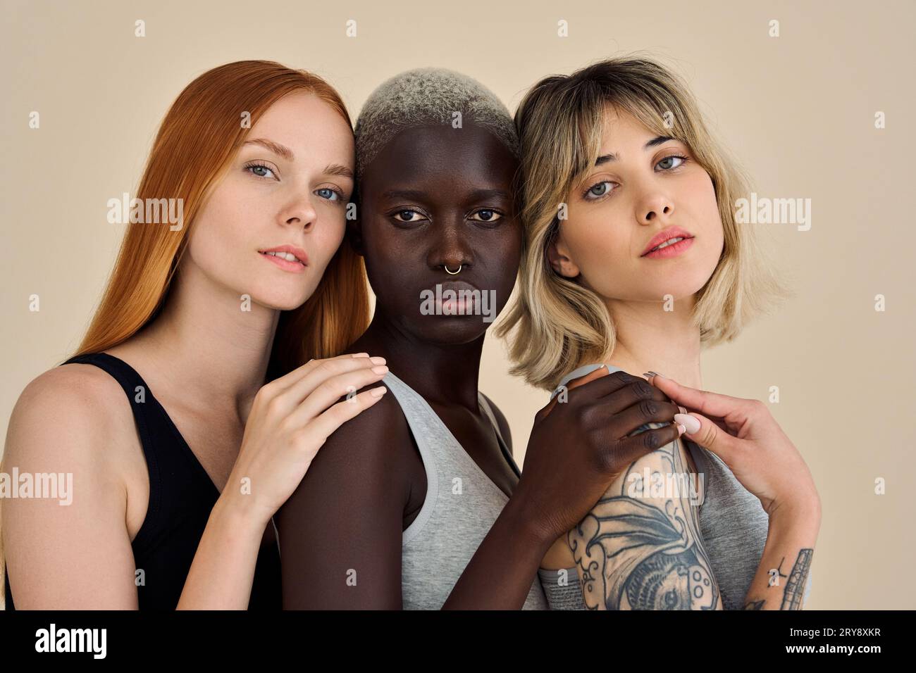Three cool confident pretty young women looking at camera, beauty ...
