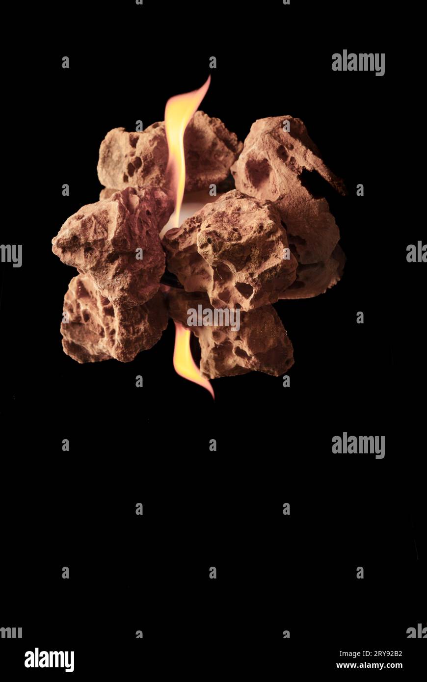 Group of colorful stones with fire flames reflected on the ground ...