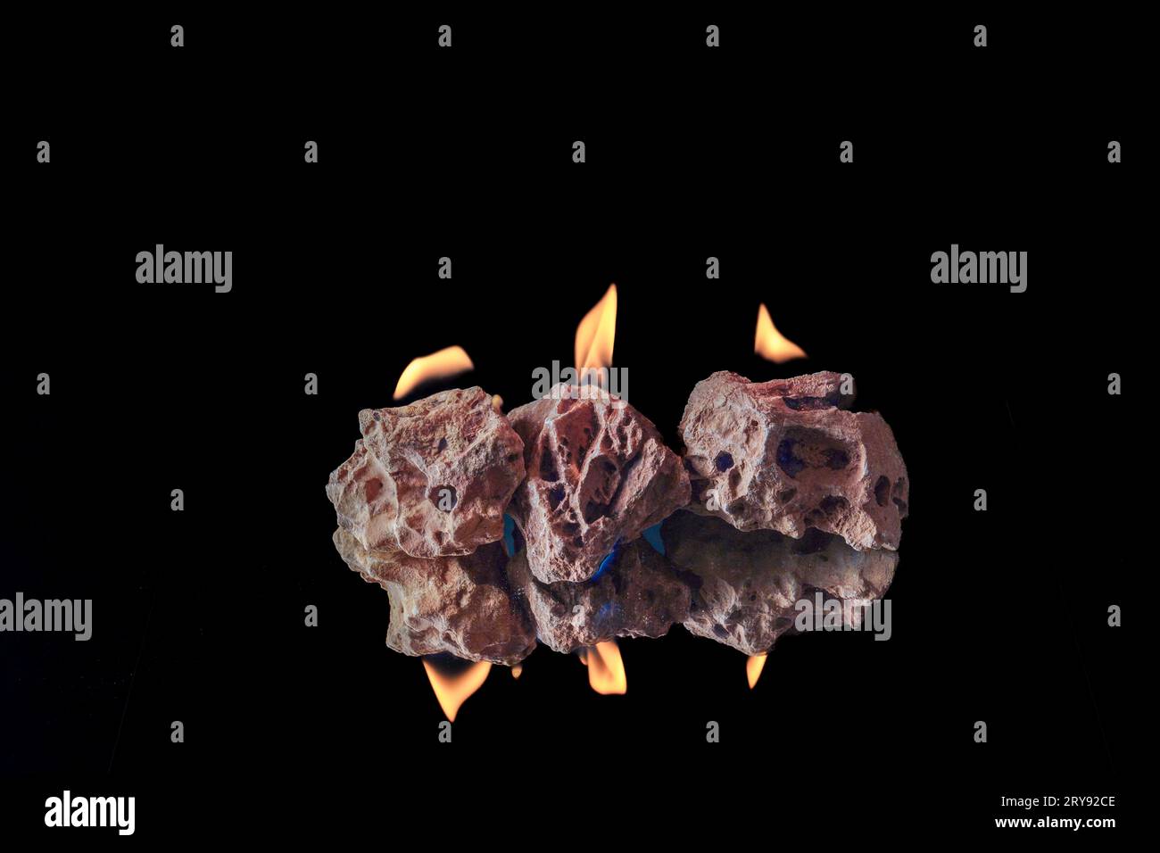 Group of colorful stones with fire flames reflected on the ground ...