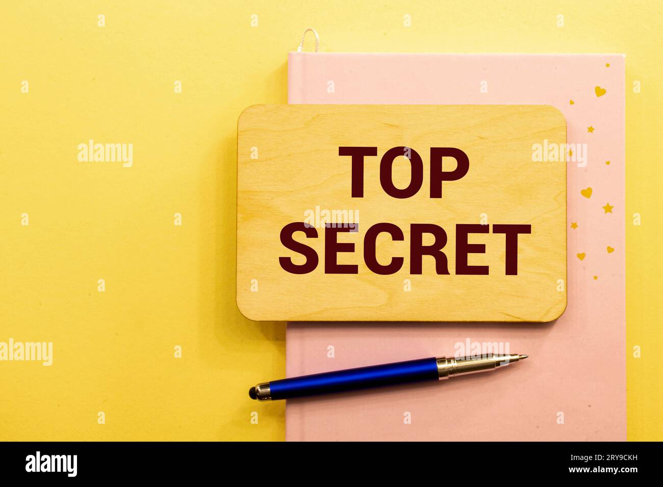 Open yellow envelope with top secret stamp and blank papers, on wooden ...