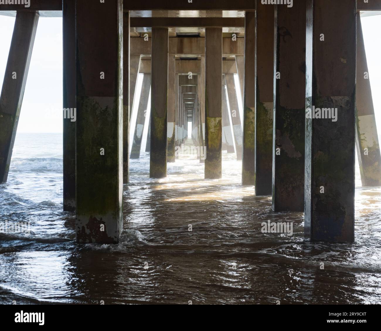 Metal beams and posts on the underside of a fishing bridge jutting out ...