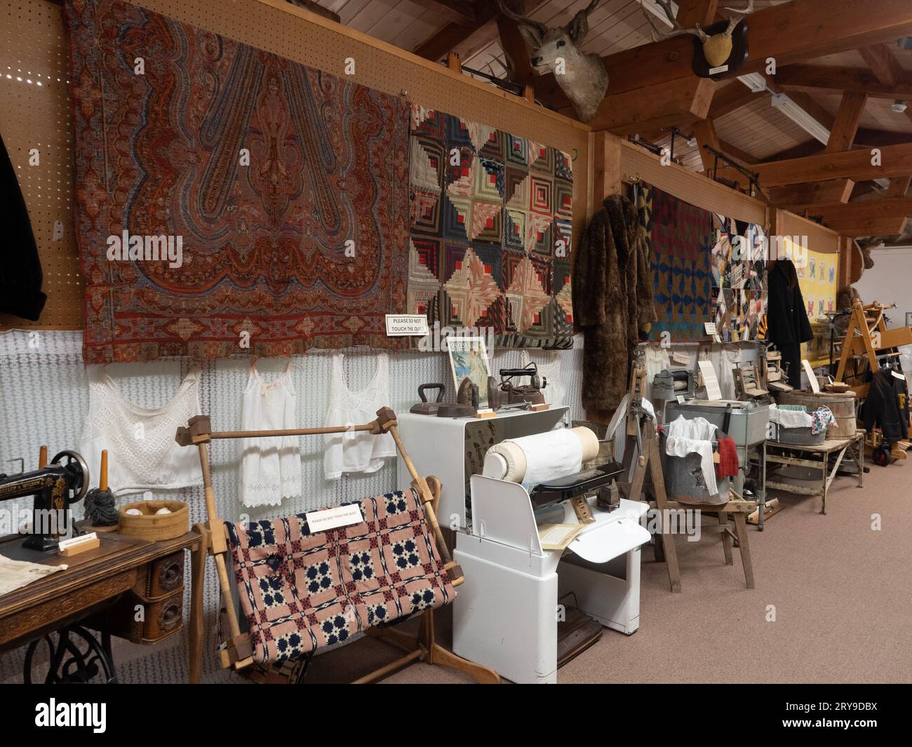 Collection of hand-sewn quilts and household items on display at the ...