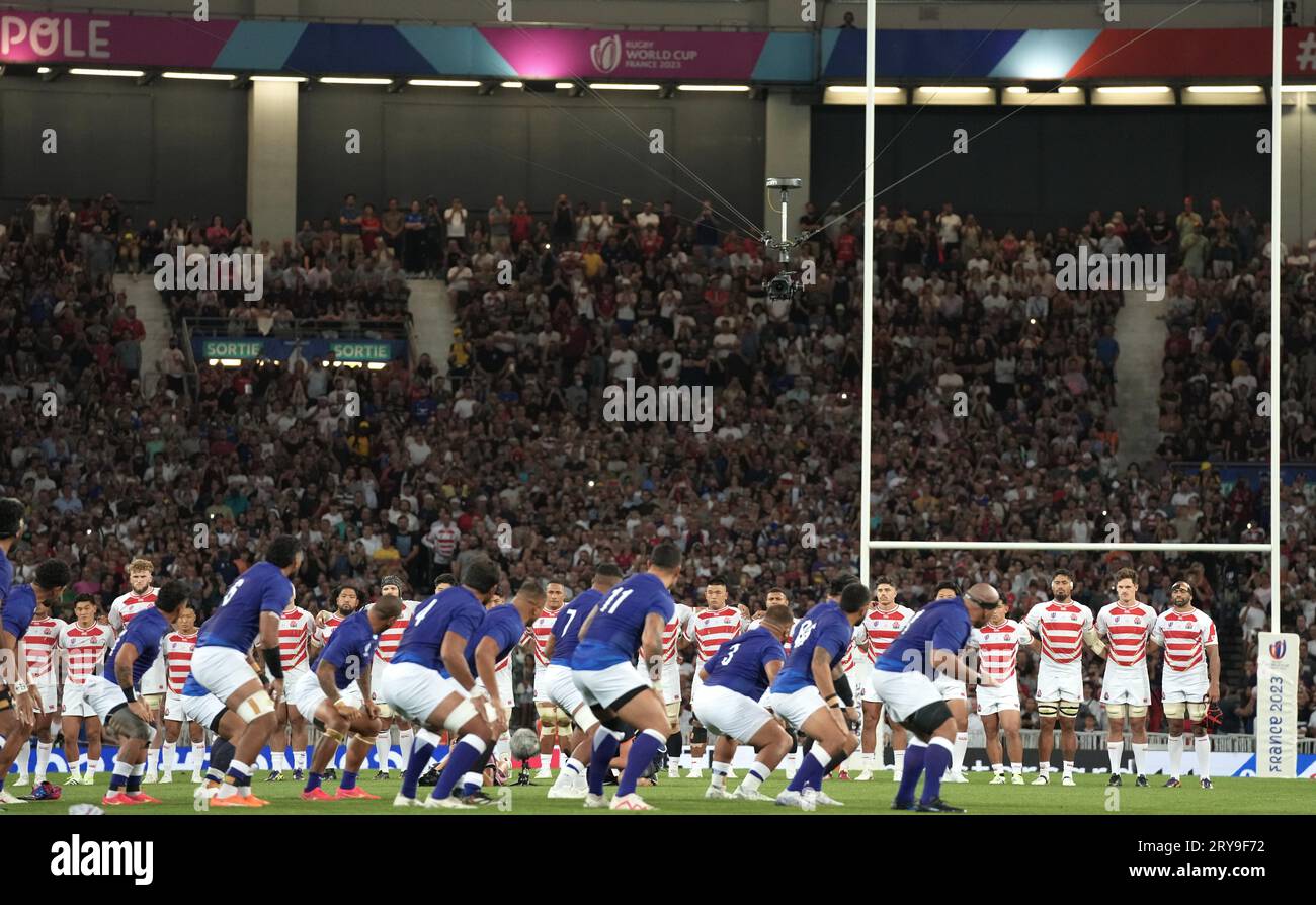 Japan players stand as Samoa players perform the Siva Tau before the ...