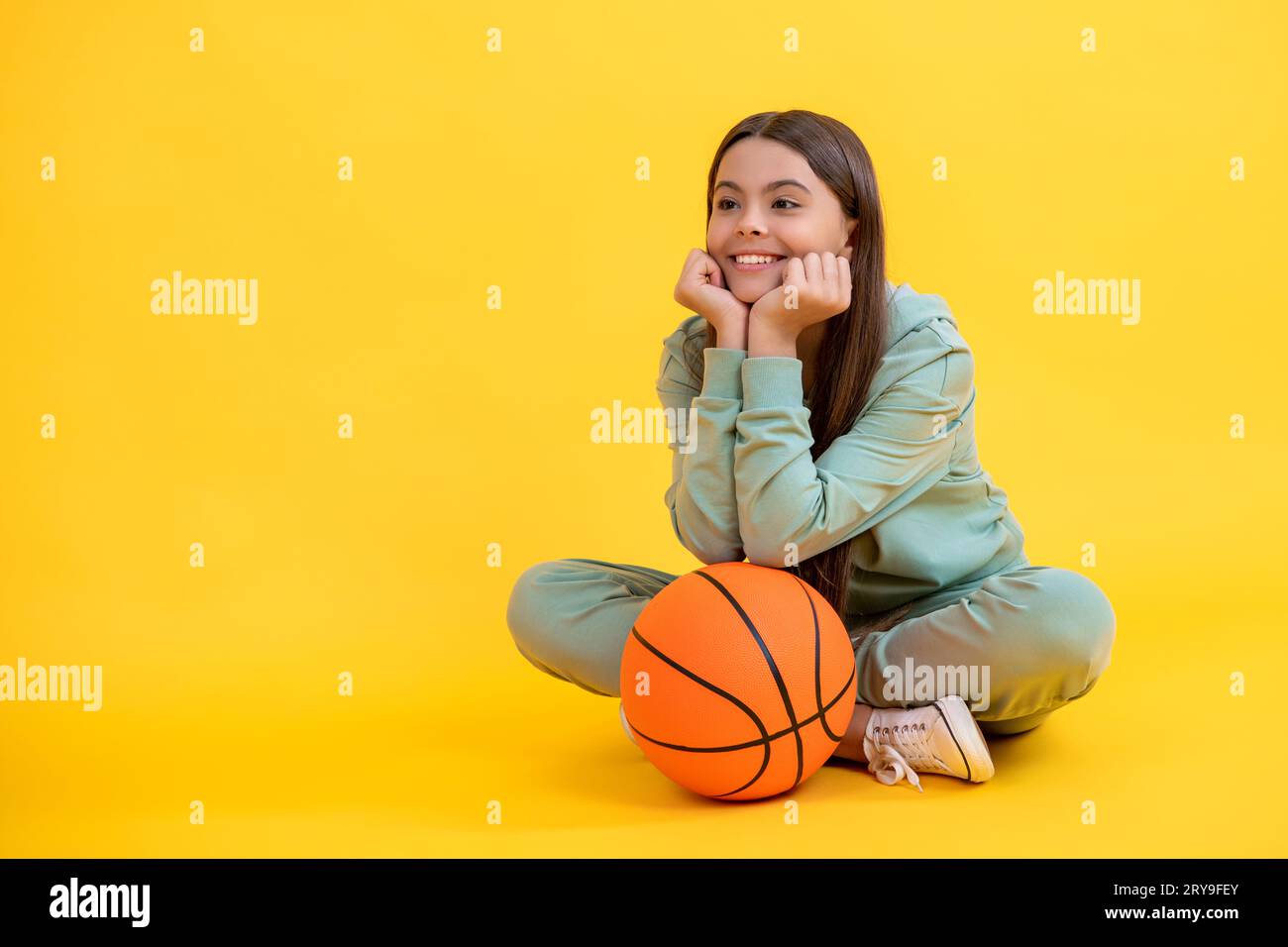 Skilled teen girl playing the basketball. Competitive teen girl playing ...
