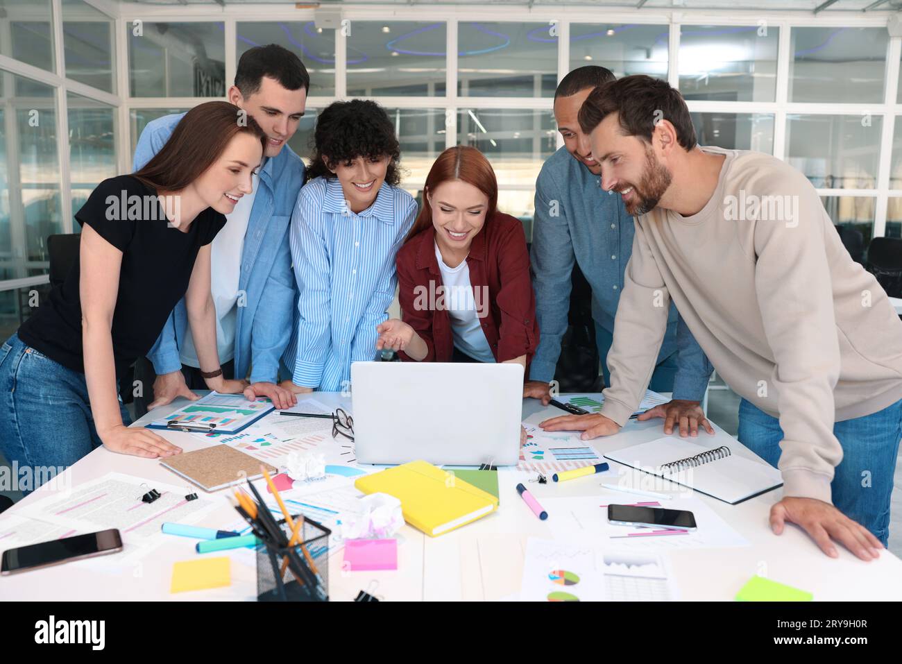 Team of employees working together at table in office. Startup project ...