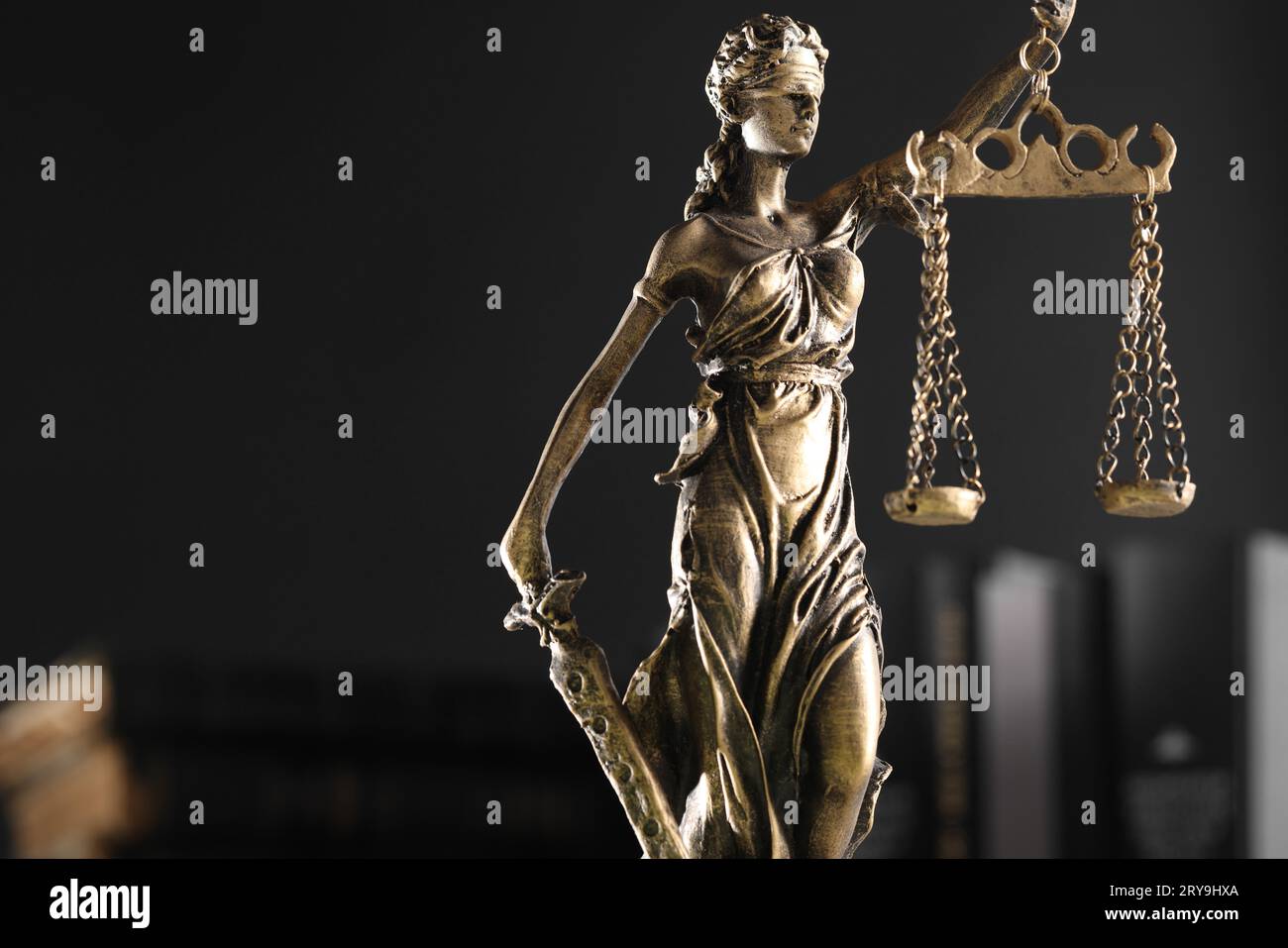 Symbol of fair treatment under law. Statue of Lady Justice on dark ...